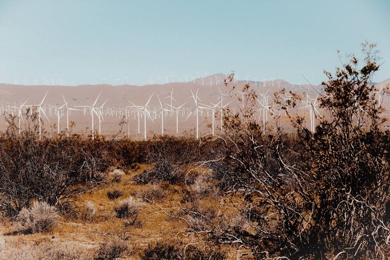 Desert and wind turbine with mountain background at Kern County ...
